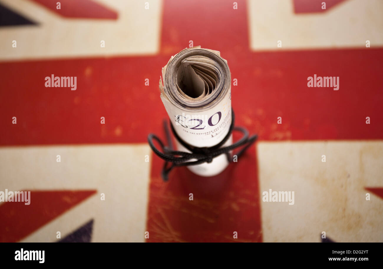 Twenty pounds sterling banknote roll on an image of a Union Jack Flag ...