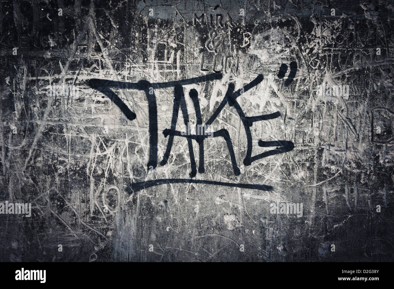 wall with inscriptions, graffiti and a big word TAKE Stock Photo - Alamy