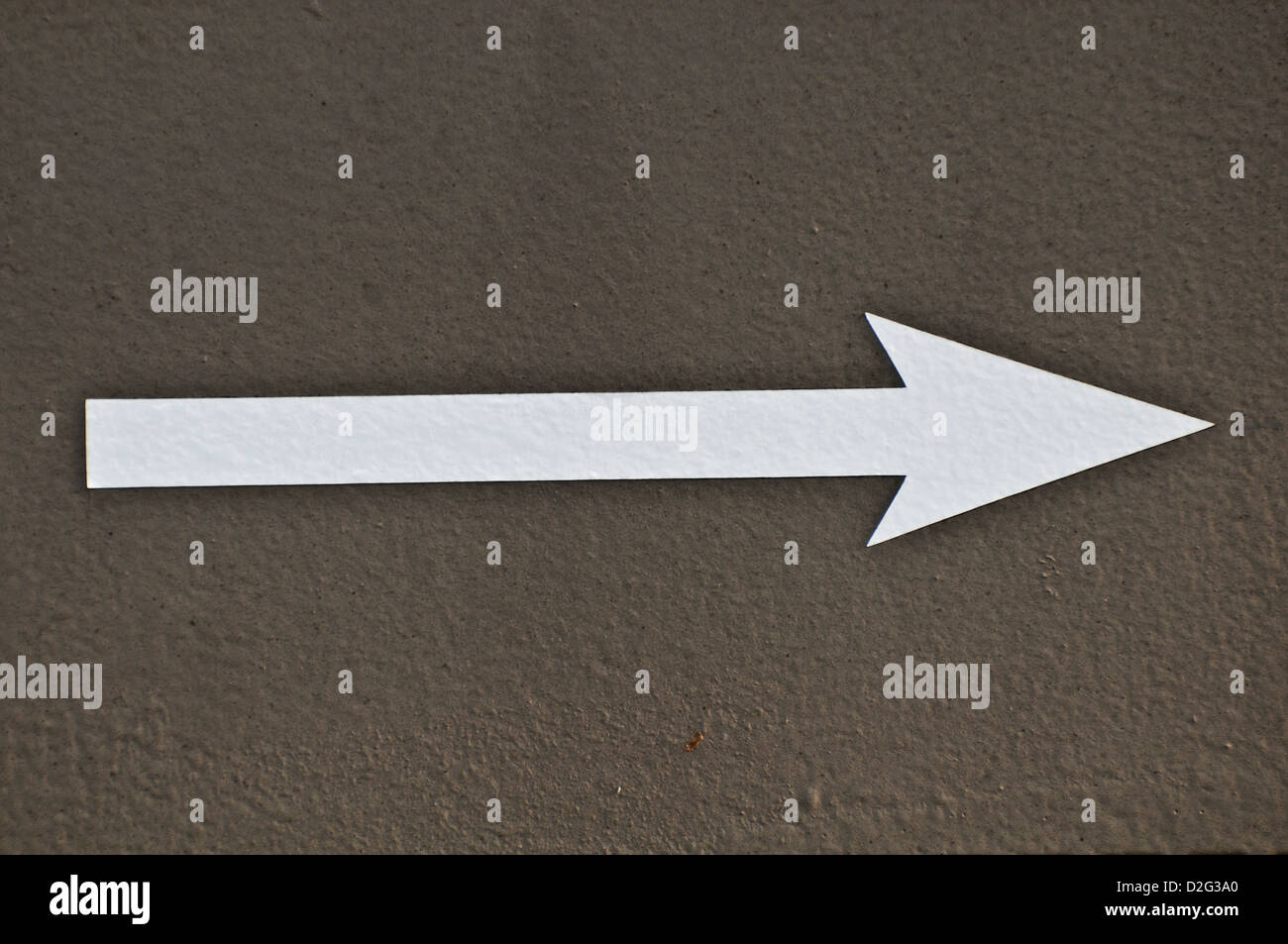 white arrow on a wall Stock Photo - Alamy