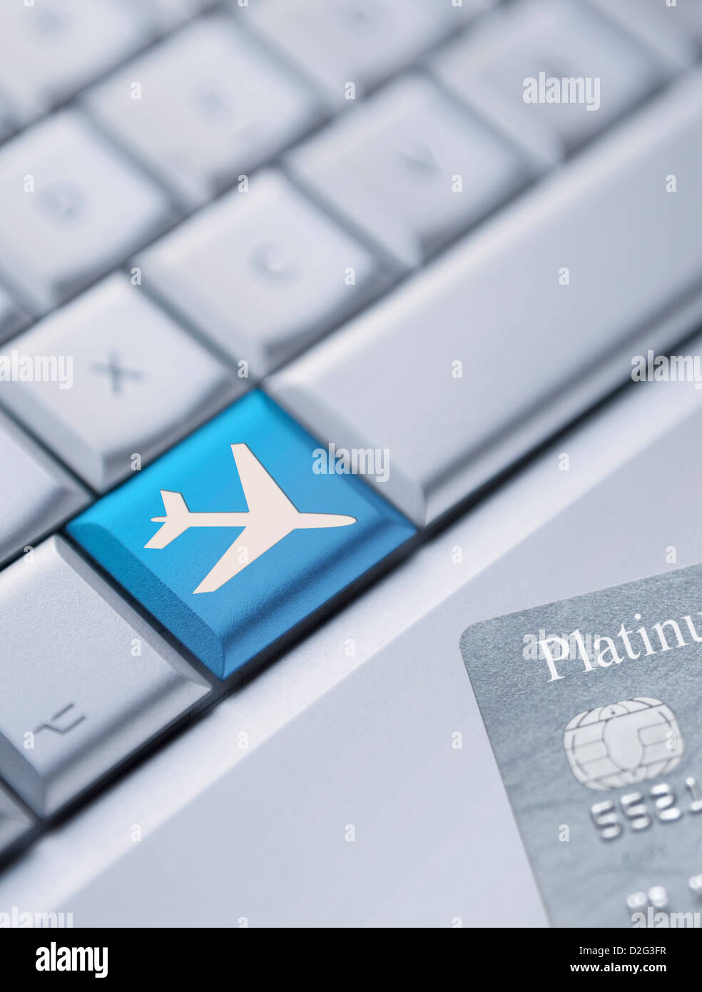 Detail of a laptop keyboard with one blue key with an plane symbol on ...