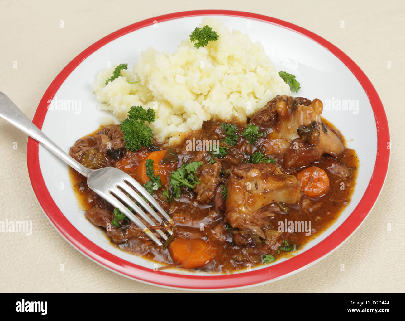 Oxtail stew, a very old British dish, on a plate with mashed potato and ...