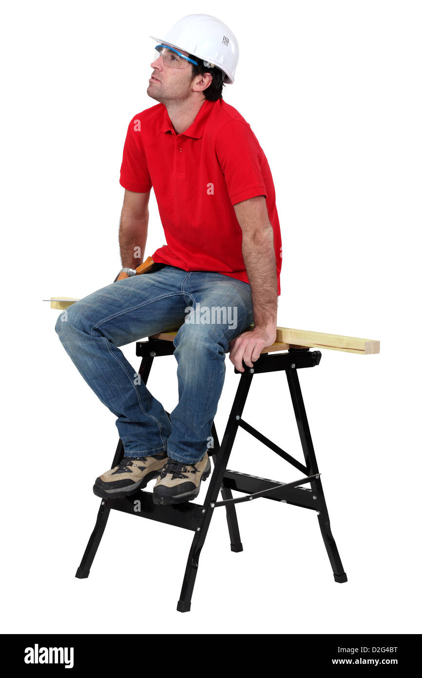 Carpenter sat on work-bench Stock Photo - Alamy