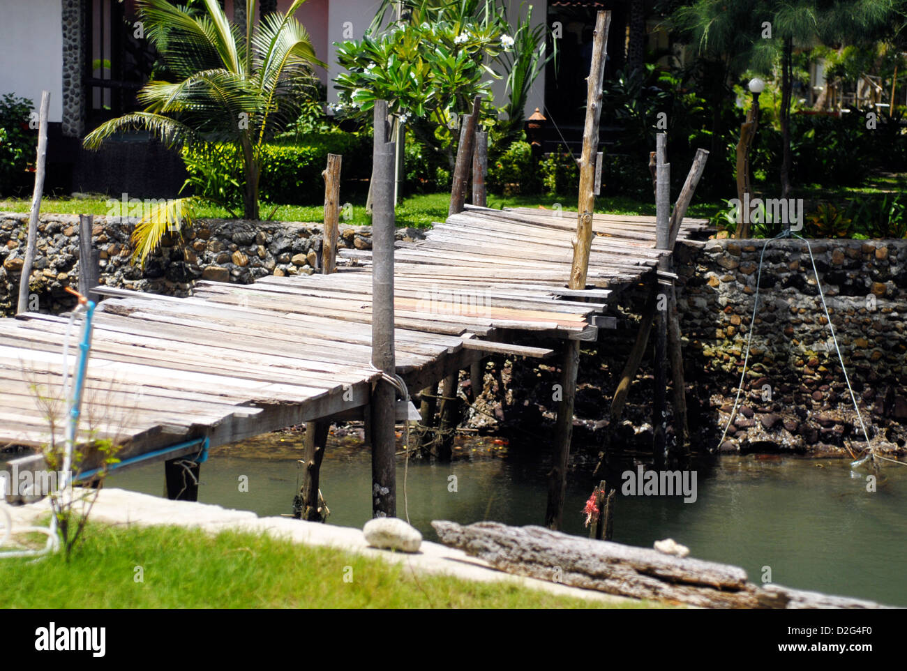 rickety old wooed bridge across the estuary of a river in ban kai bae ...