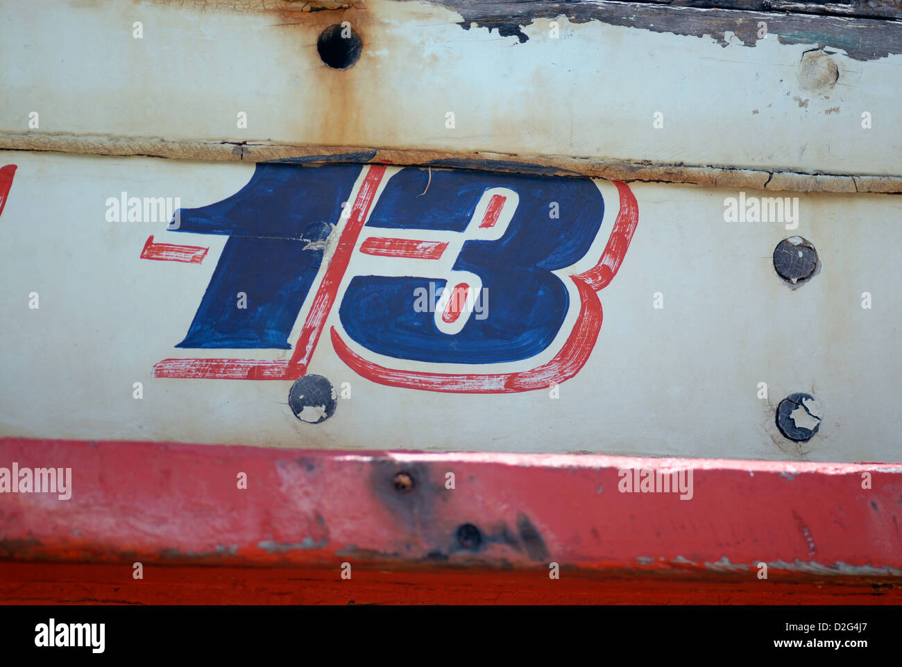 close up of ships hull with the number 13 hand painted onto its side ...