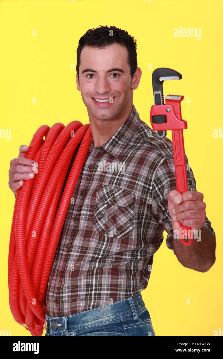 Handsome smiling plumber at the kitchen hi-res stock photography and ...