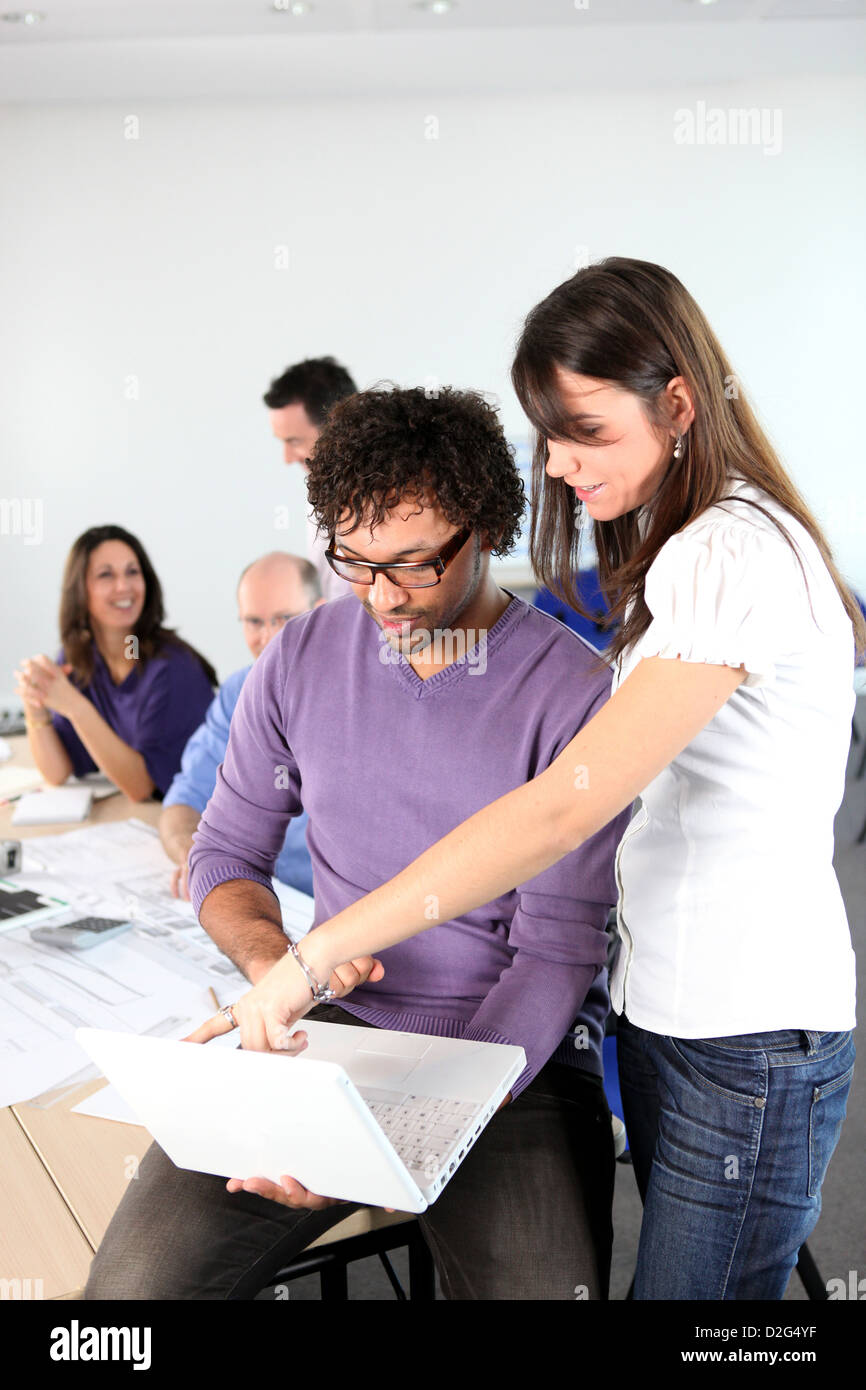 Woman pointing something out to her colleague Stock Photo - Alamy