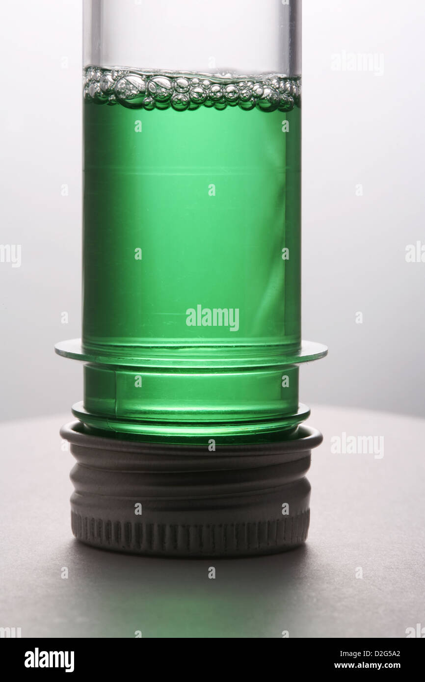 Test tube with a green liquid on a white background Stock Photo - Alamy