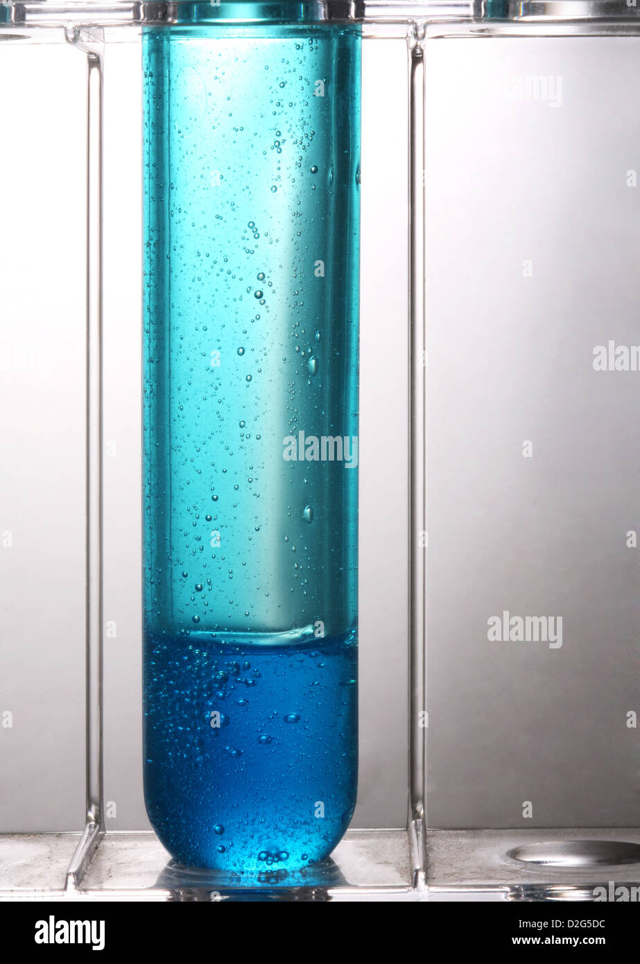 Test tube with a dark blue liquid on a white background Stock Photo - Alamy