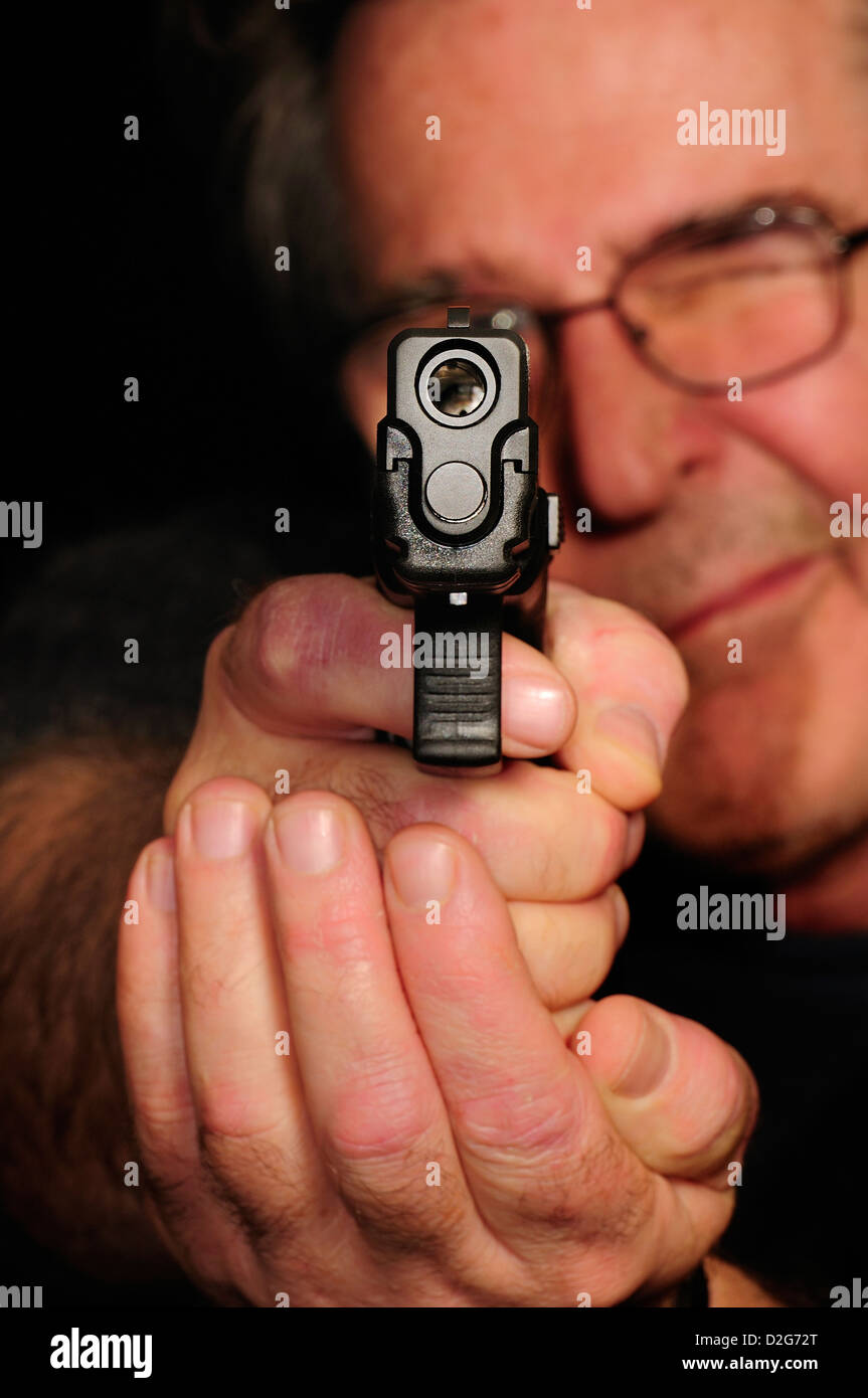 Man aiming semi-automatic pistol Stock Photo - Alamy