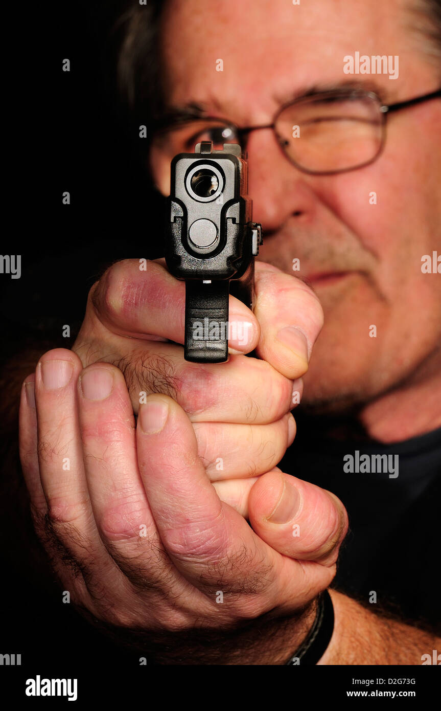 Man aiming semi-automatic pistol Stock Photo - Alamy