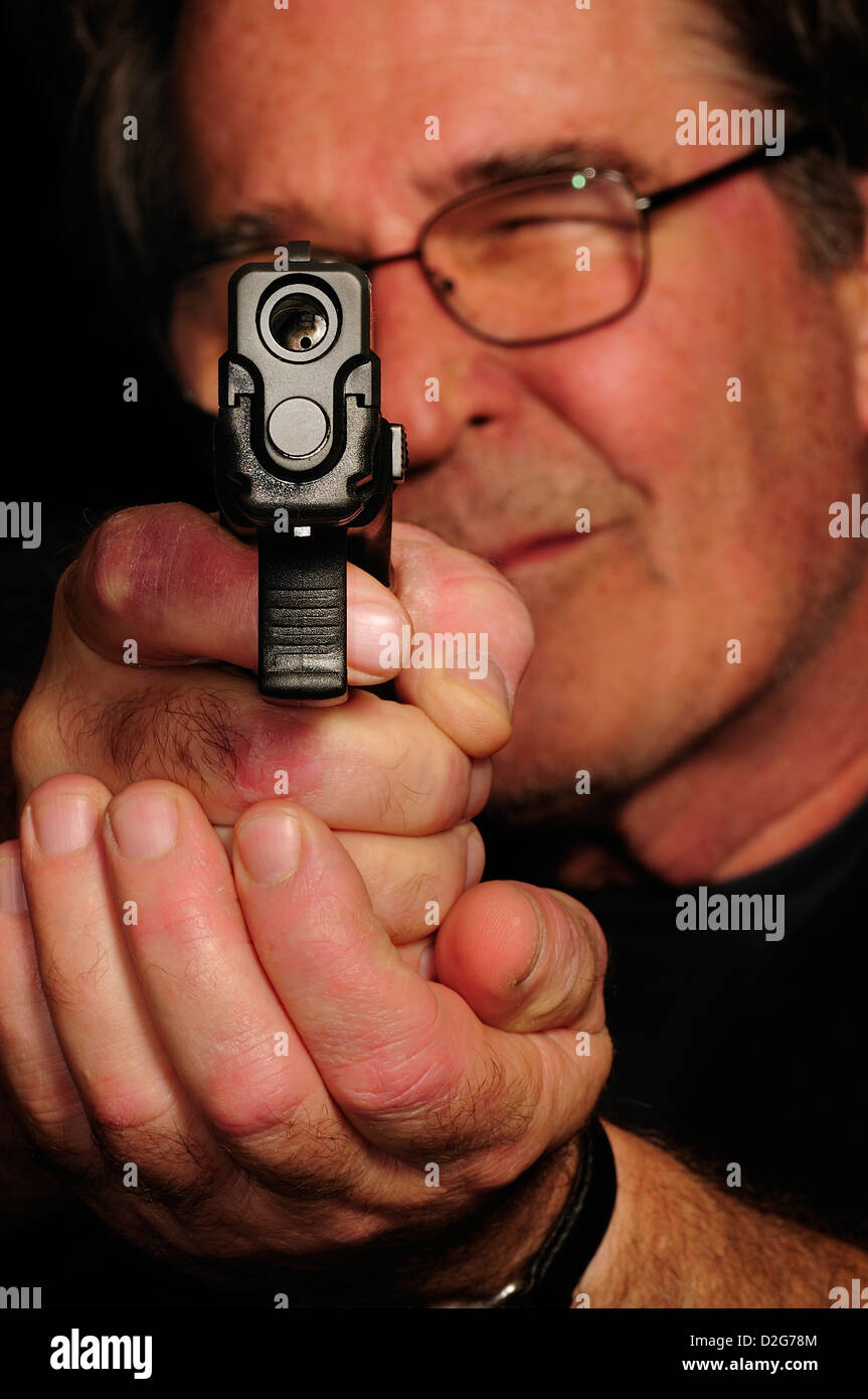Man aiming semi-automatic pistol Stock Photo - Alamy