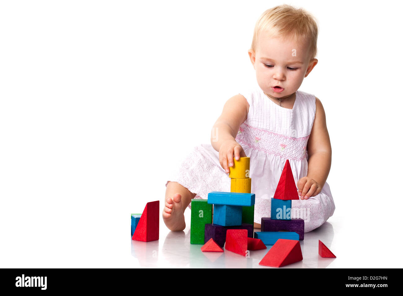 Beautiful baby building a castle with cubes isolated on white Stock ...