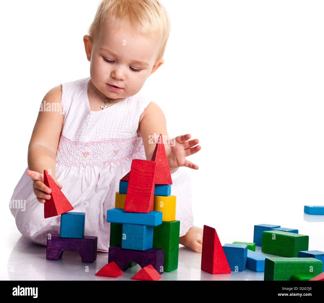 Beautiful baby building a castle with cubes isolated on white Stock ...