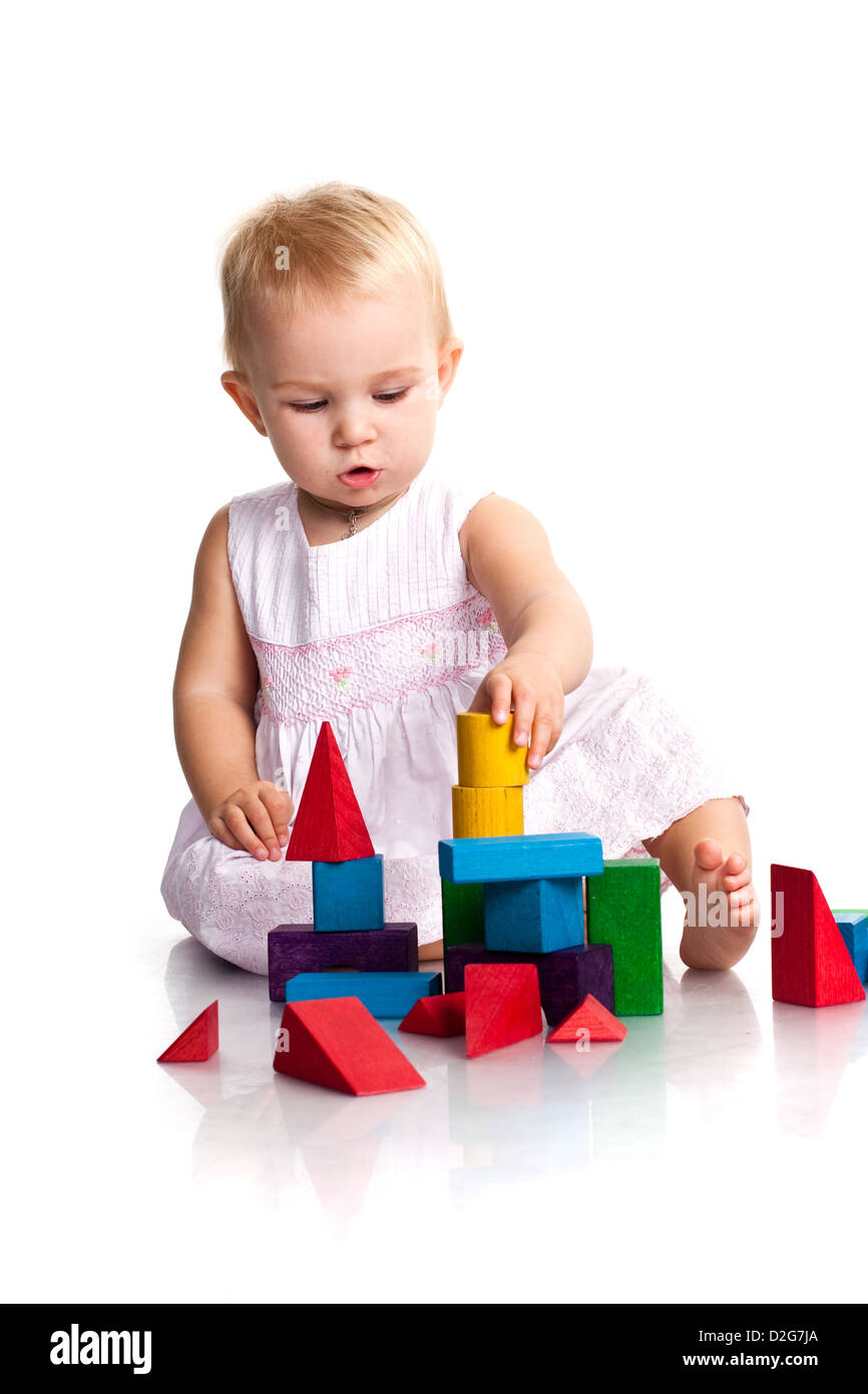 Beautiful baby building a castle with cubes isolated on white Stock ...