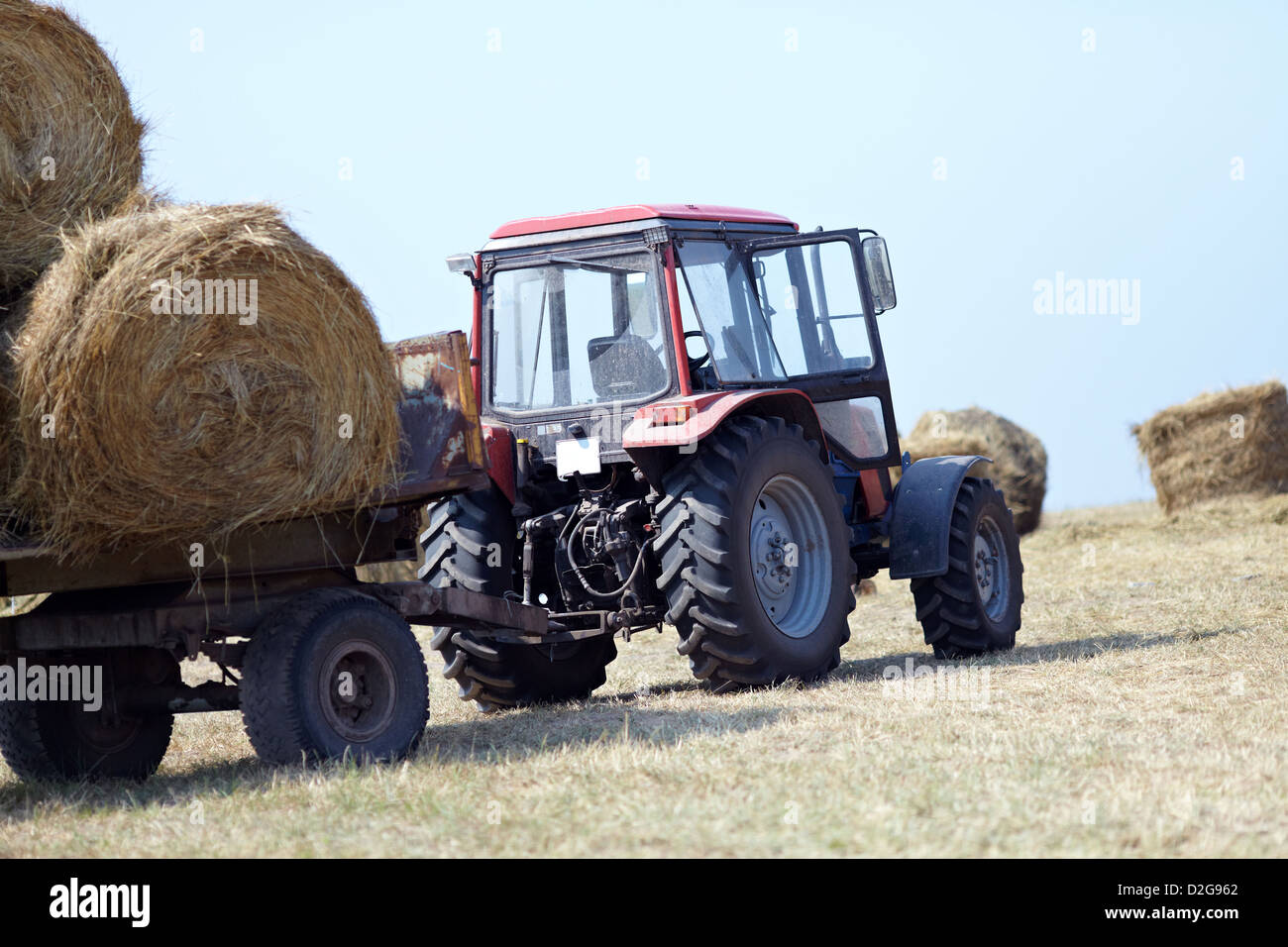 Agriculture - tractor carries a haystack Stock Photo - Alamy
