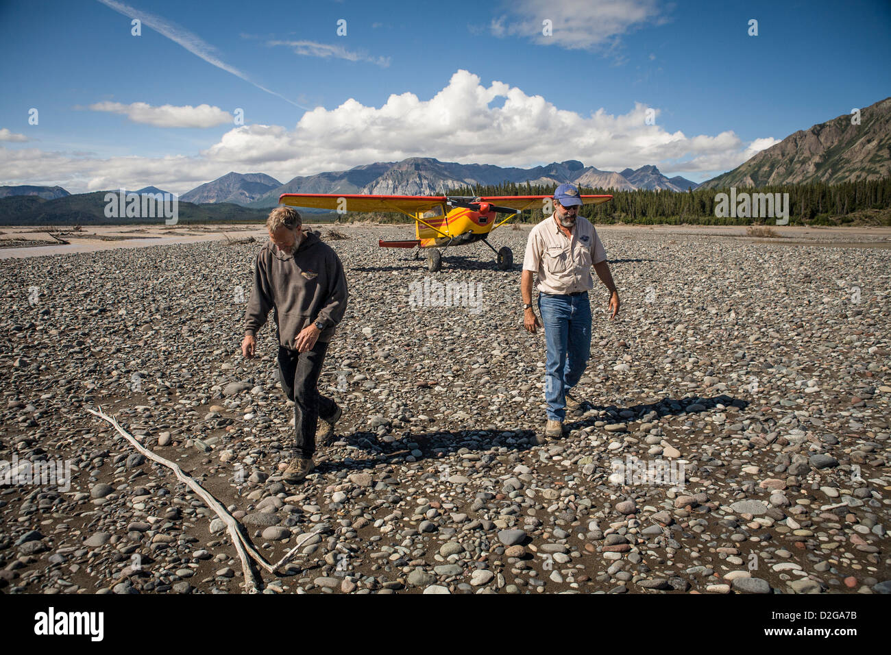 Pilots Don Welty and Kelly Bay on a gravel bar on the Nebesna river ...