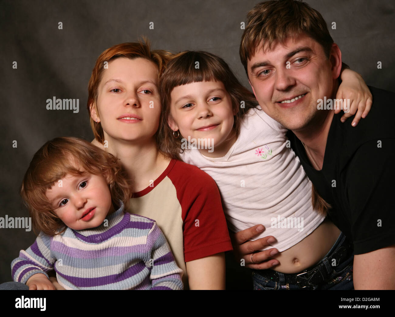 Family portrait on a dark background in studio Stock Photo - Alamy