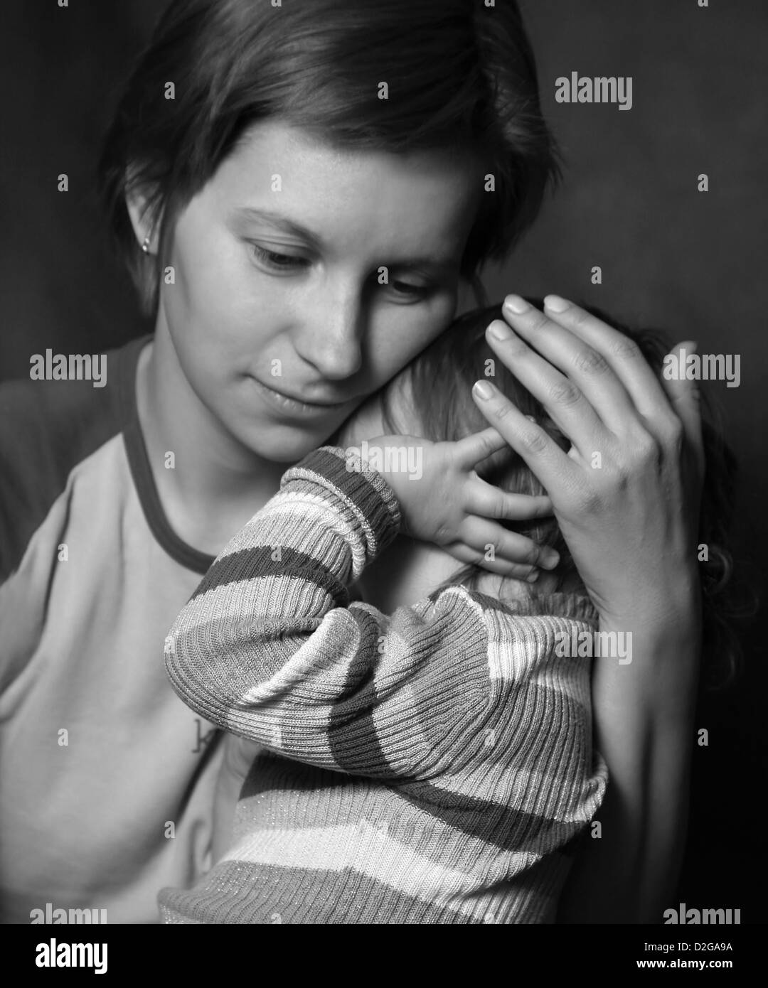 Mother gently embraces the crying child. b/w Stock Photo - Alamy