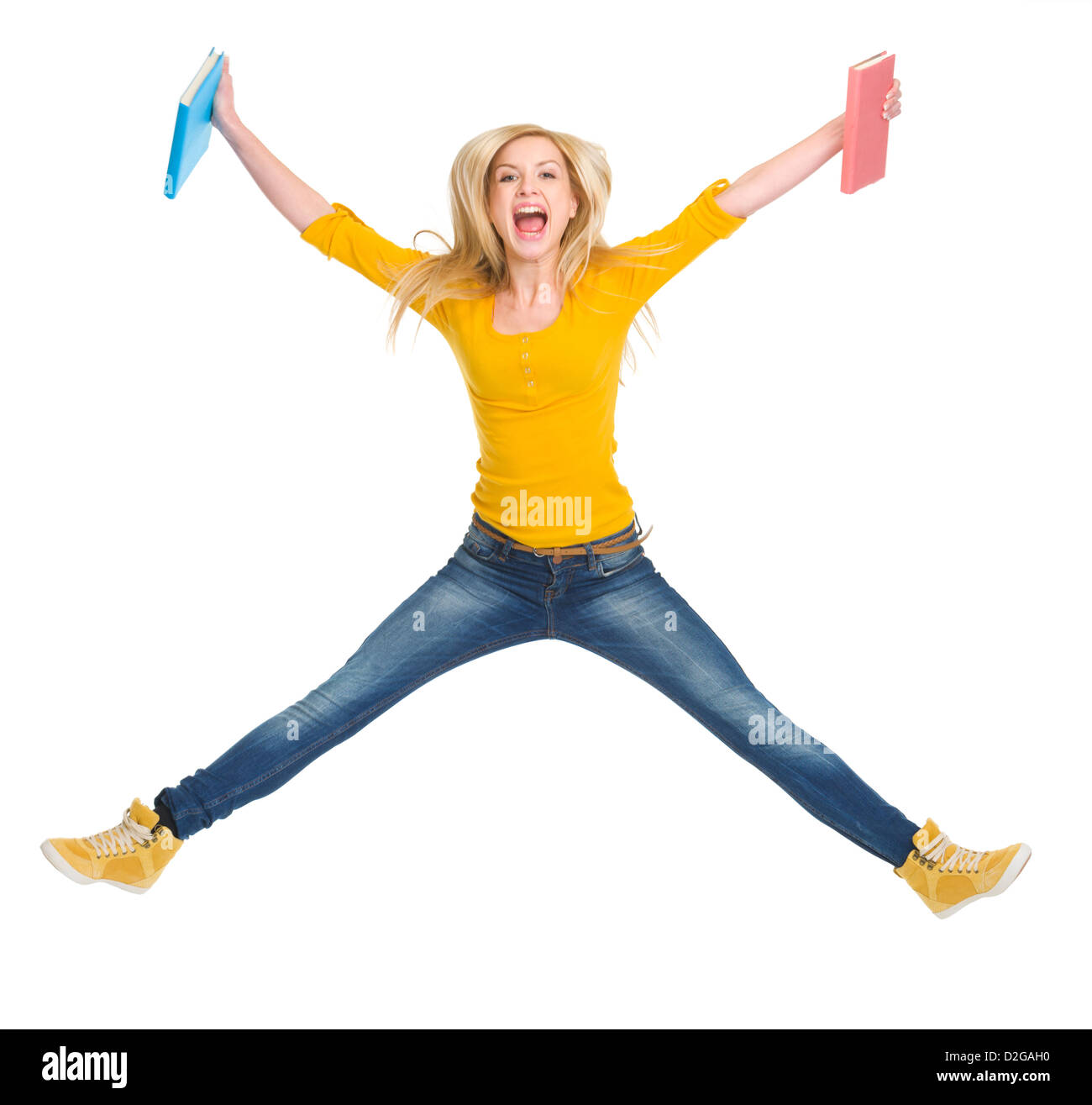 Happy student girl with books jumping Stock Photo - Alamy