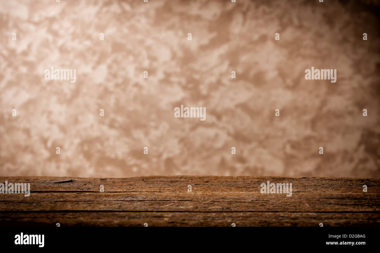 Background with wooden table and beige grunge wall Stock Photo - Alamy