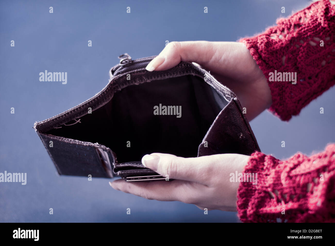 Woman holding empty wallet Stock Photo - Alamy