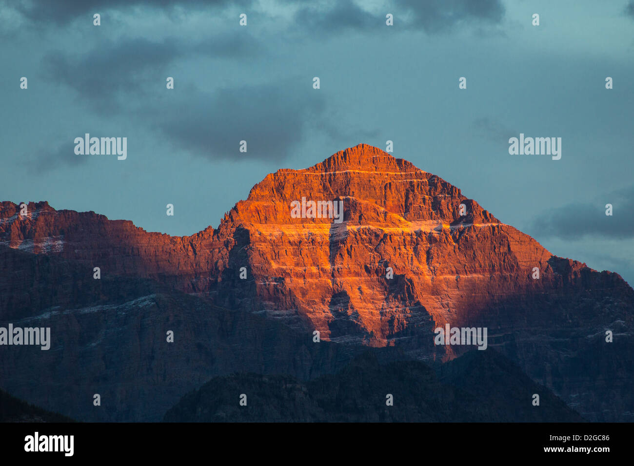 Warm sunset light on mountain peak in Waterton Lakes National Park in ...
