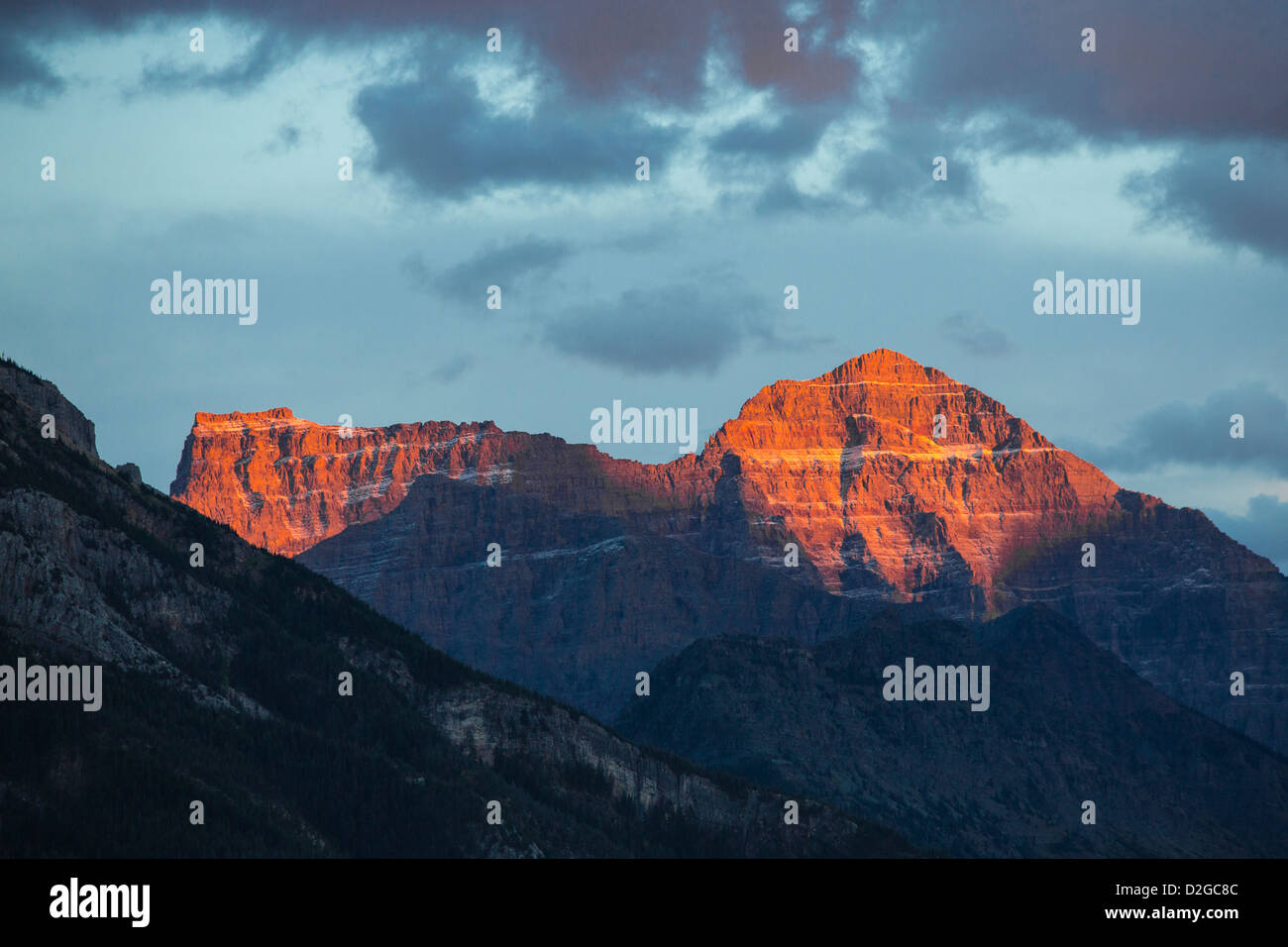 Warm sunset light on mountain peaks in Waterton Lakes National Park in ...