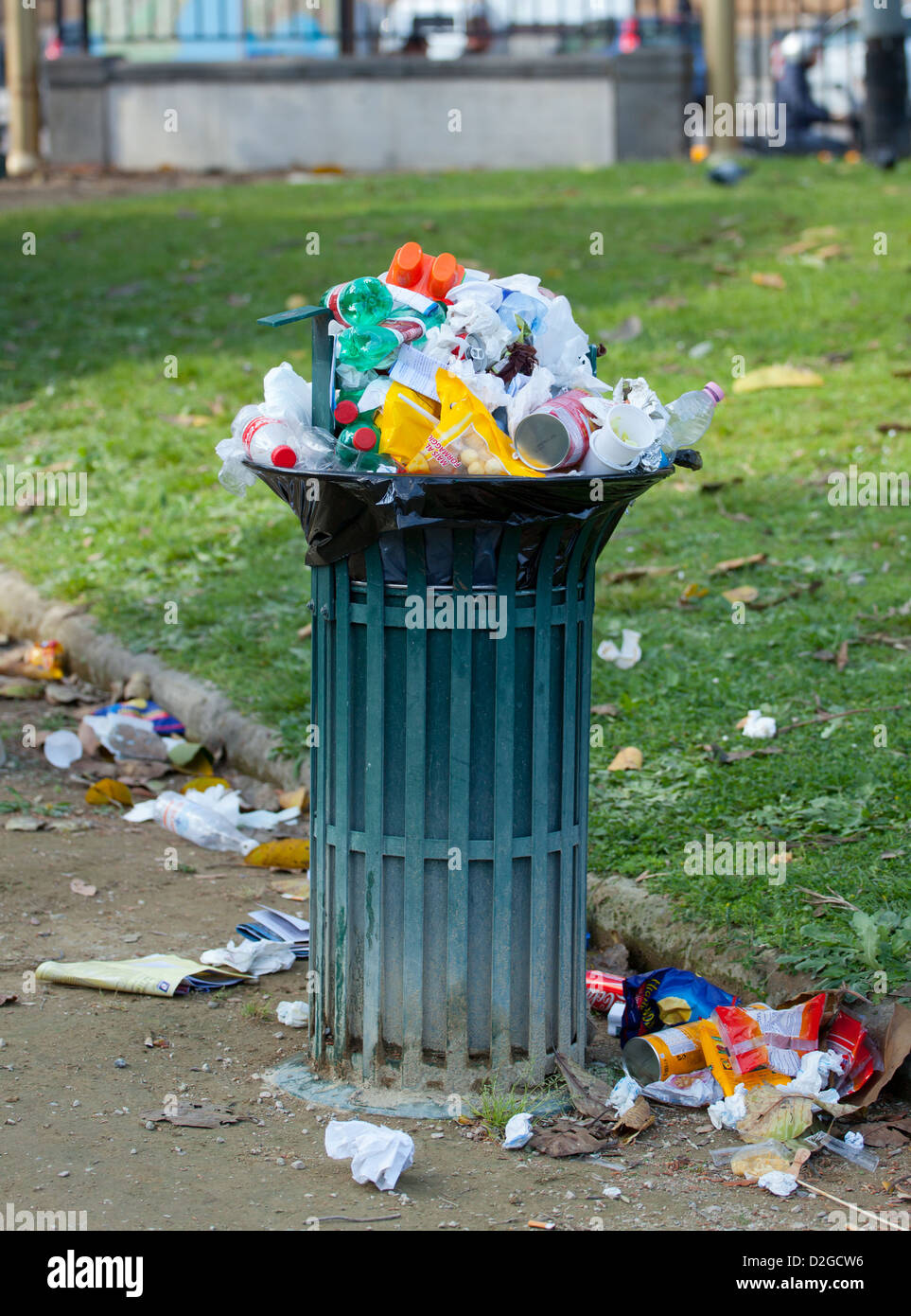 Trash basket full in park Stock Photo - Alamy
