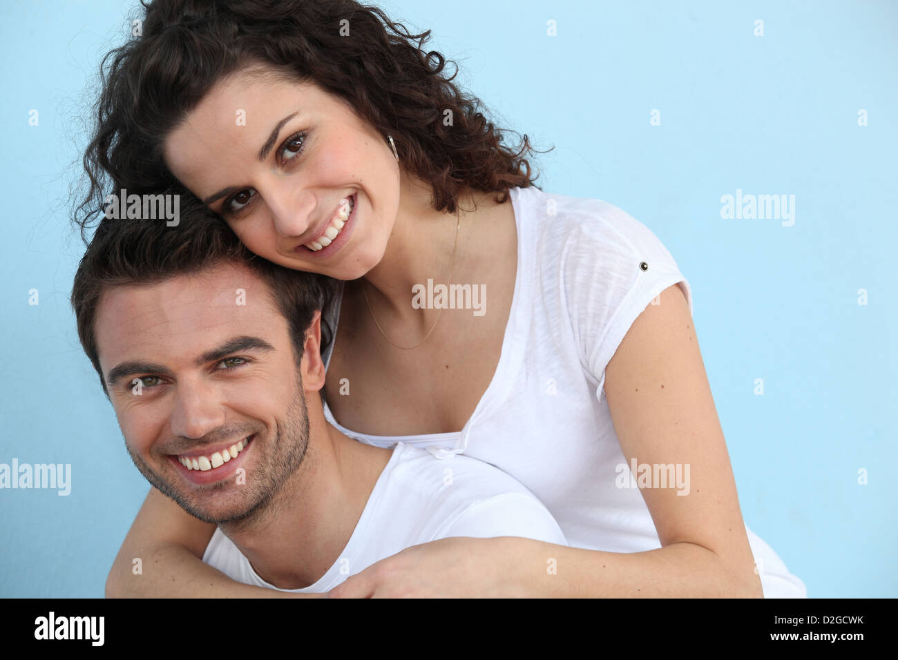 Man giving girlfriend piggy-back Stock Photo - Alamy