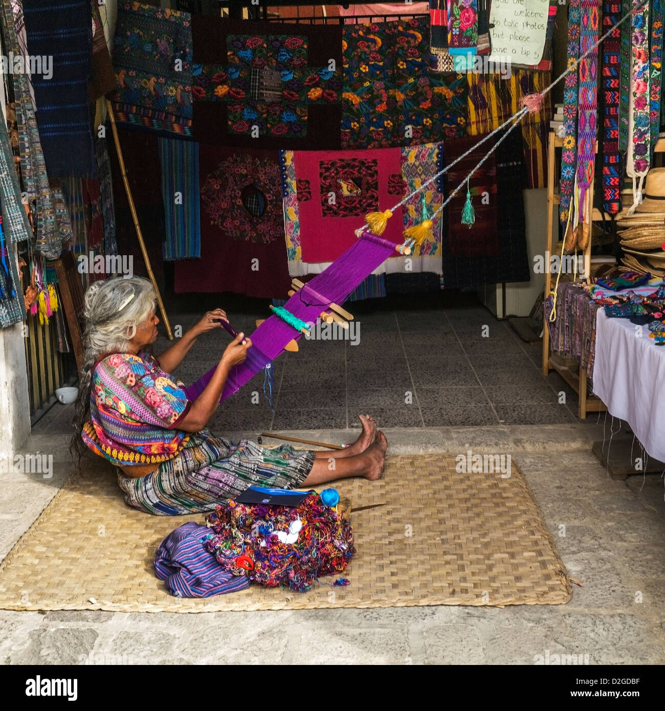 Maya Indian woman weaves at her traditional crafts shop in Antigua ...