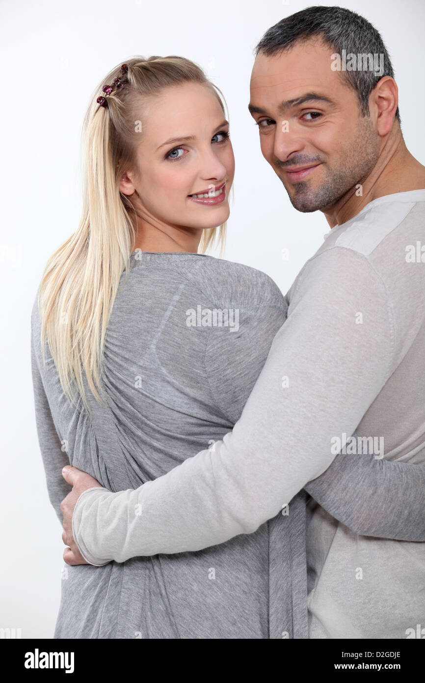 Couple looking over their shoulders Stock Photo - Alamy