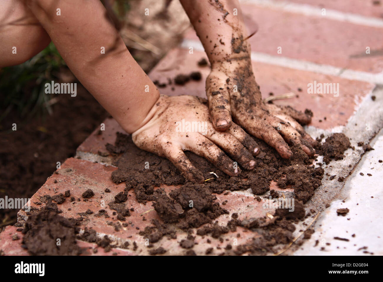 A child plays in the mud Stock Photo - Alamy