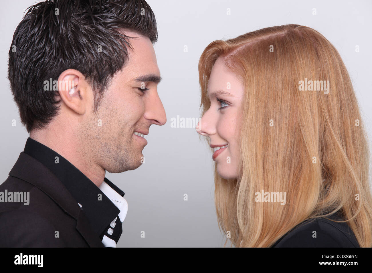 Man and woman standing face to face Stock Photo - Alamy