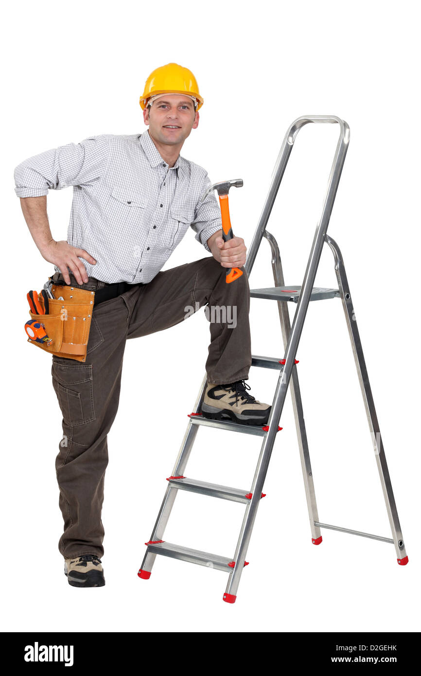 carpenter with leg resting on ladder holding hammer Stock Photo - Alamy