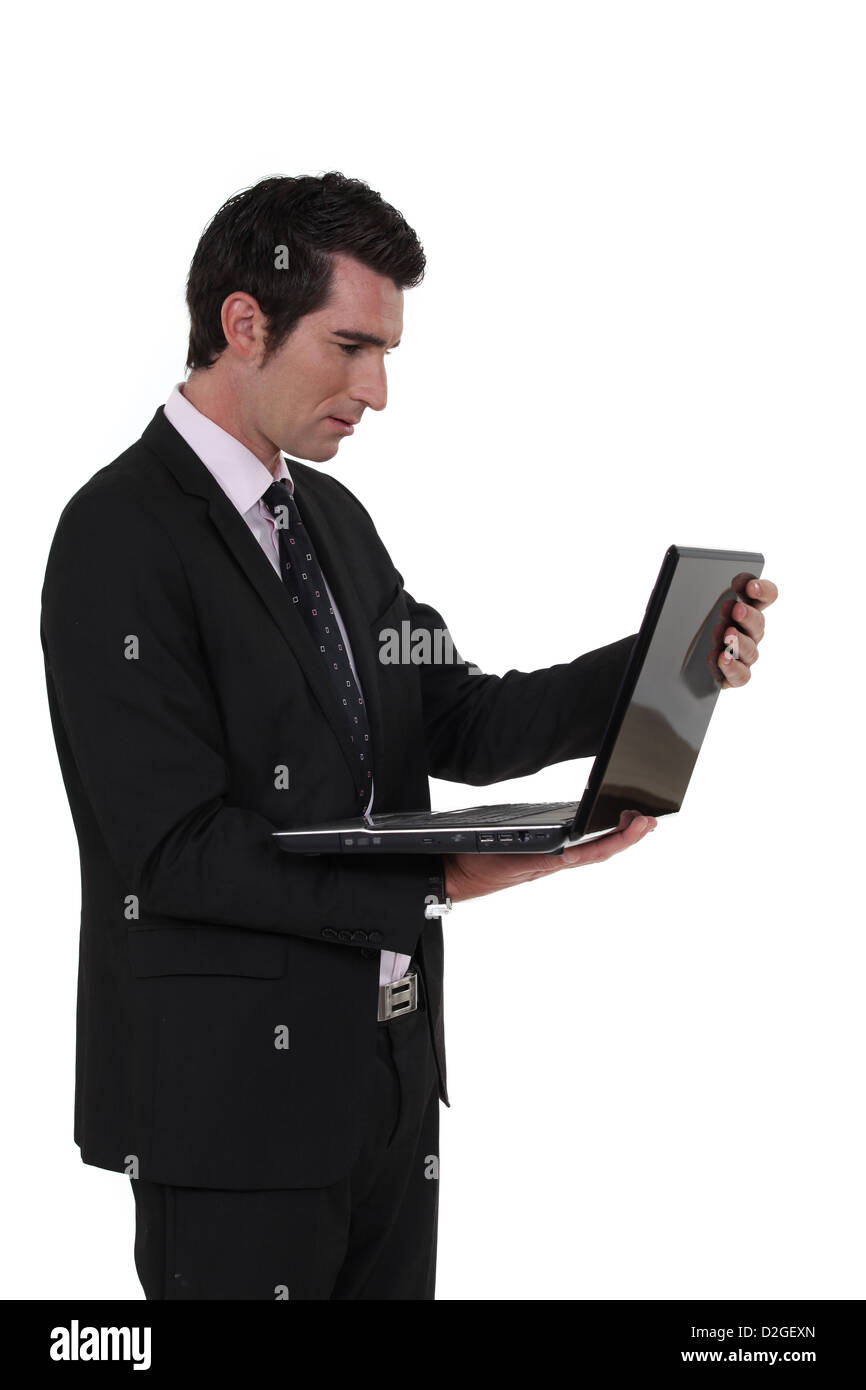 Businessman carrying laptop Stock Photo - Alamy
