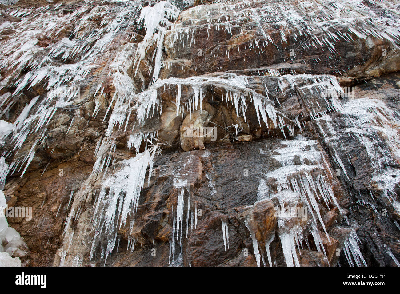 Cliff covered in ice cycles Stock Photo - Alamy