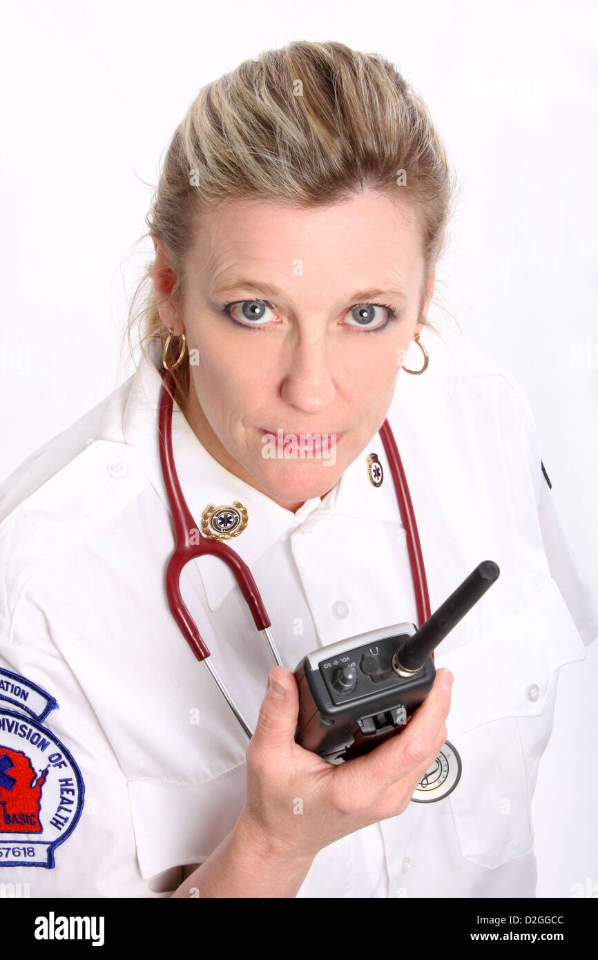 A Wisconsin EMT wearing a stethoscope and talking on a portable radio ...