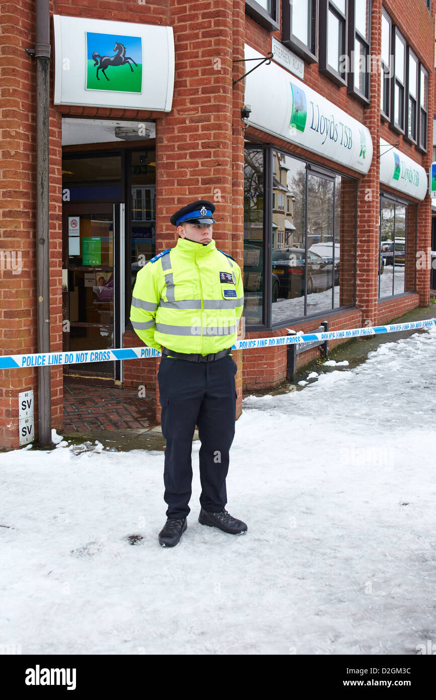 Police officers guard the scene of an armed bank robbery at Lloyds TSB ...