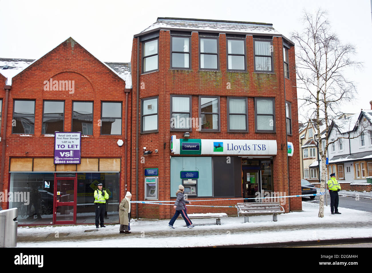 Police officers guard the scene of an armed bank robbery at Lloyds TSB ...