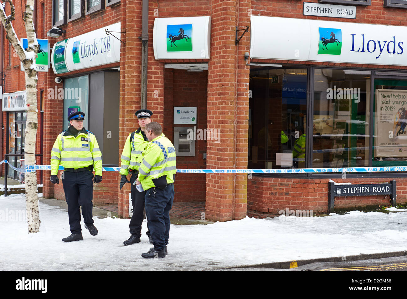 Police officers guard the scene of an armed bank robbery at Lloyds TSB ...