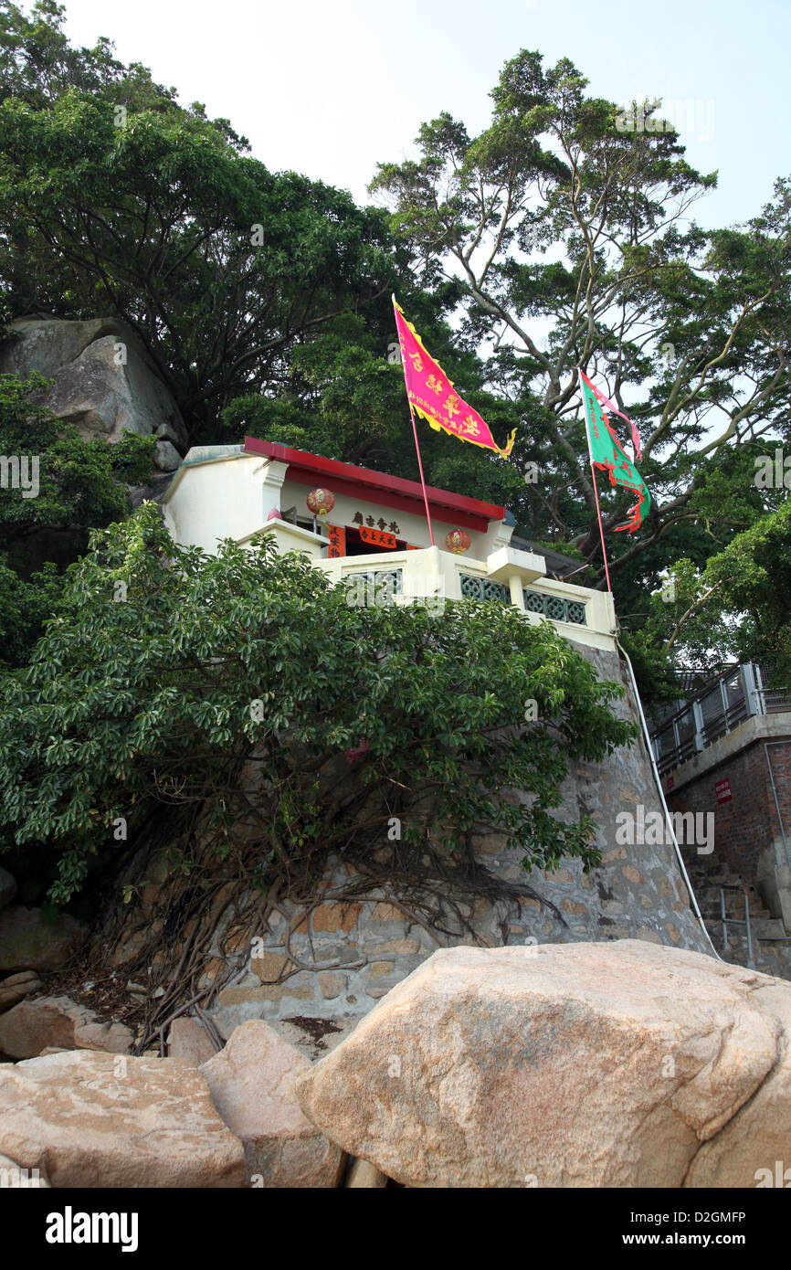 It's a photo of a Chinese Temple that is on a rock in nature. We can ...
