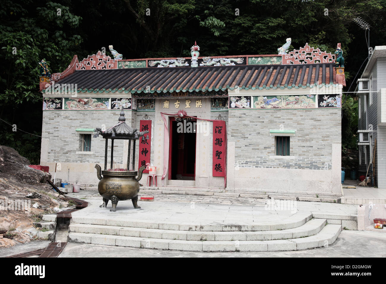 It's a photo of a Chinese Temple that is on a rock in nature. We can ...