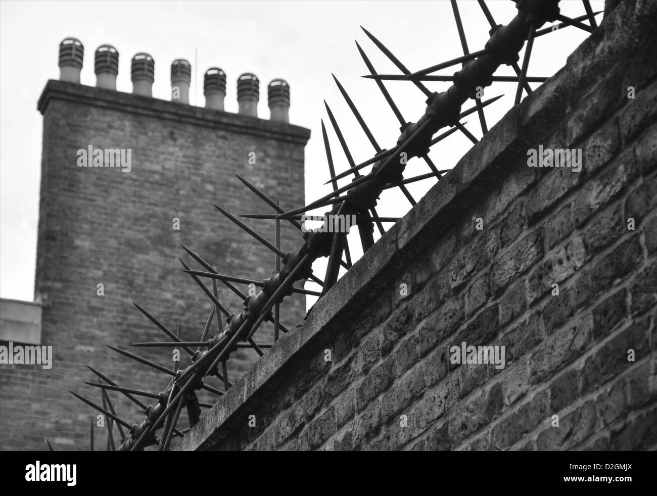 Barbed wire on a wall Stock Photo - Alamy