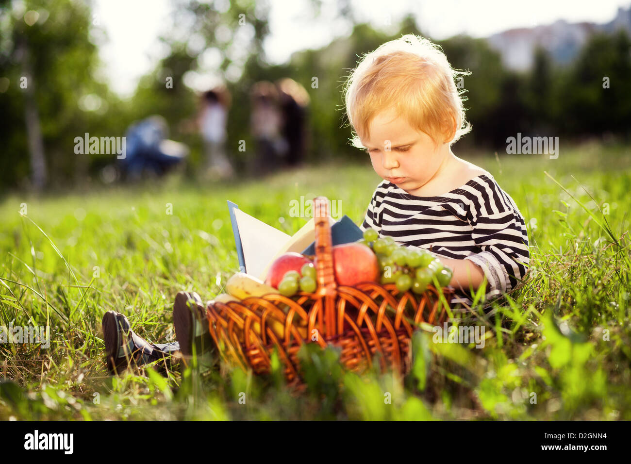 little boy looks at a book Stock Photo - Alamy