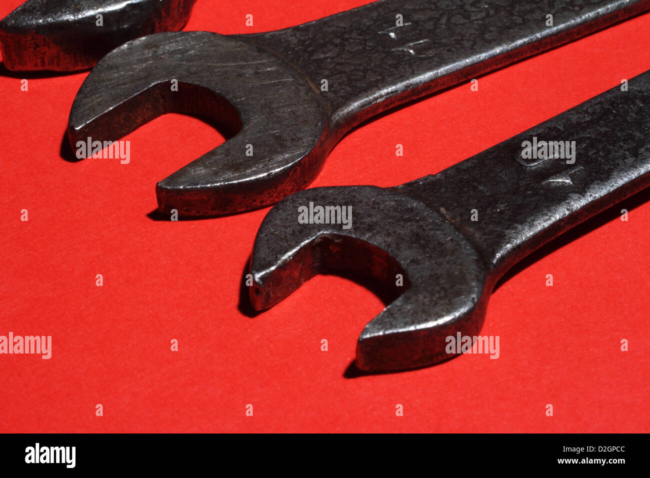 old spanners over red Stock Photo - Alamy