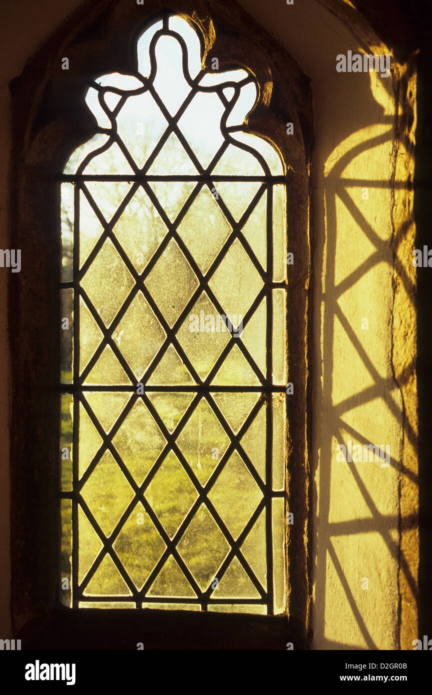 15th century Perpendicular Gothic diamond leaded window in warm early ...