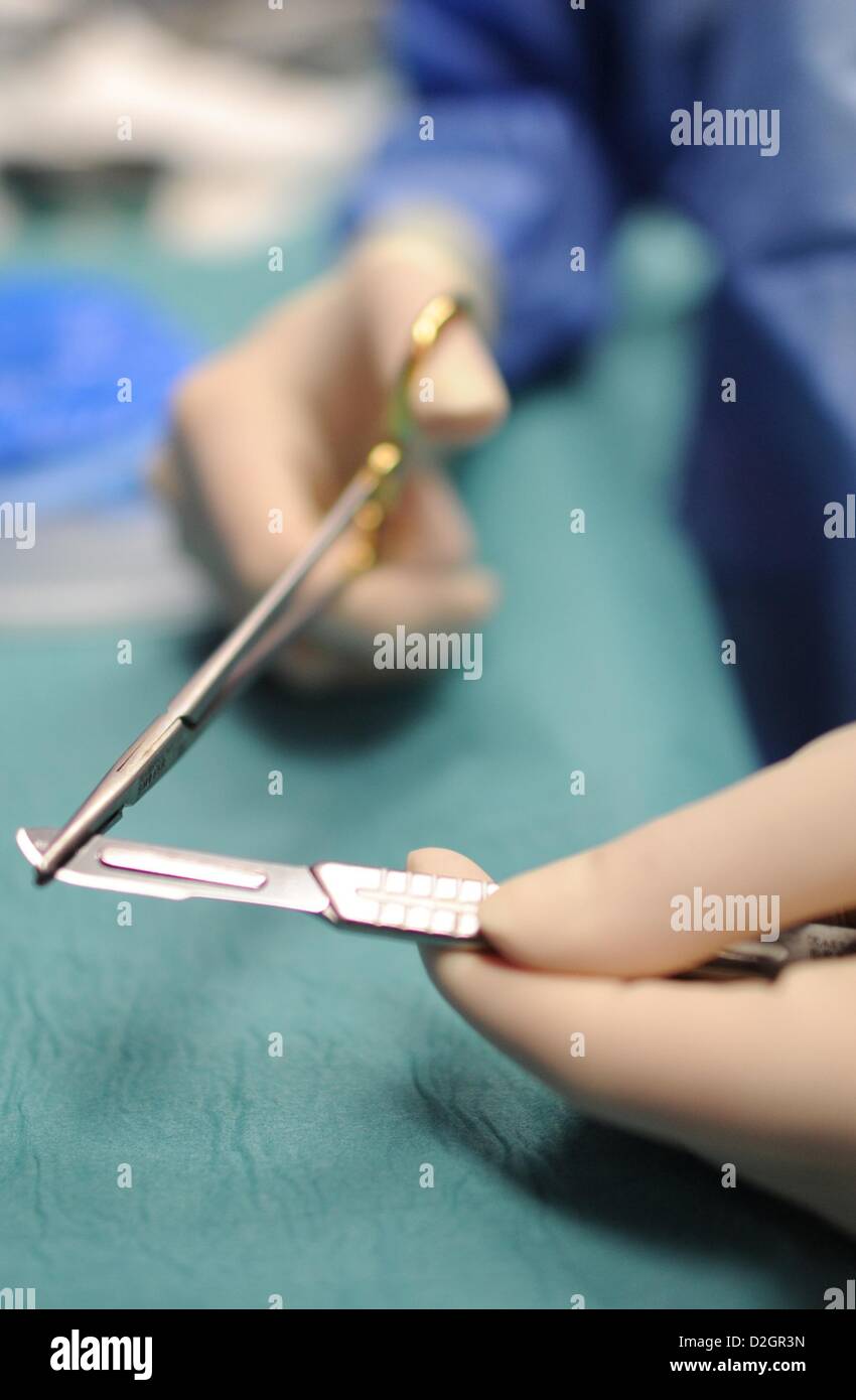 A surgical nurse prepares surgical instruments in the operating room of ...