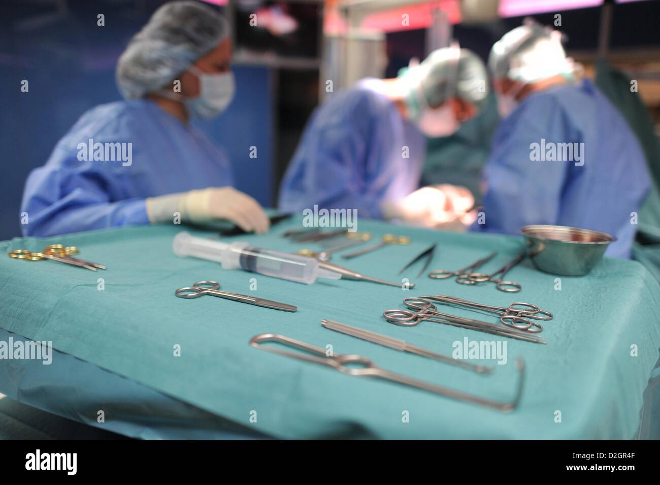 Prepared surgical instruments lay on a table in the operating room of ...