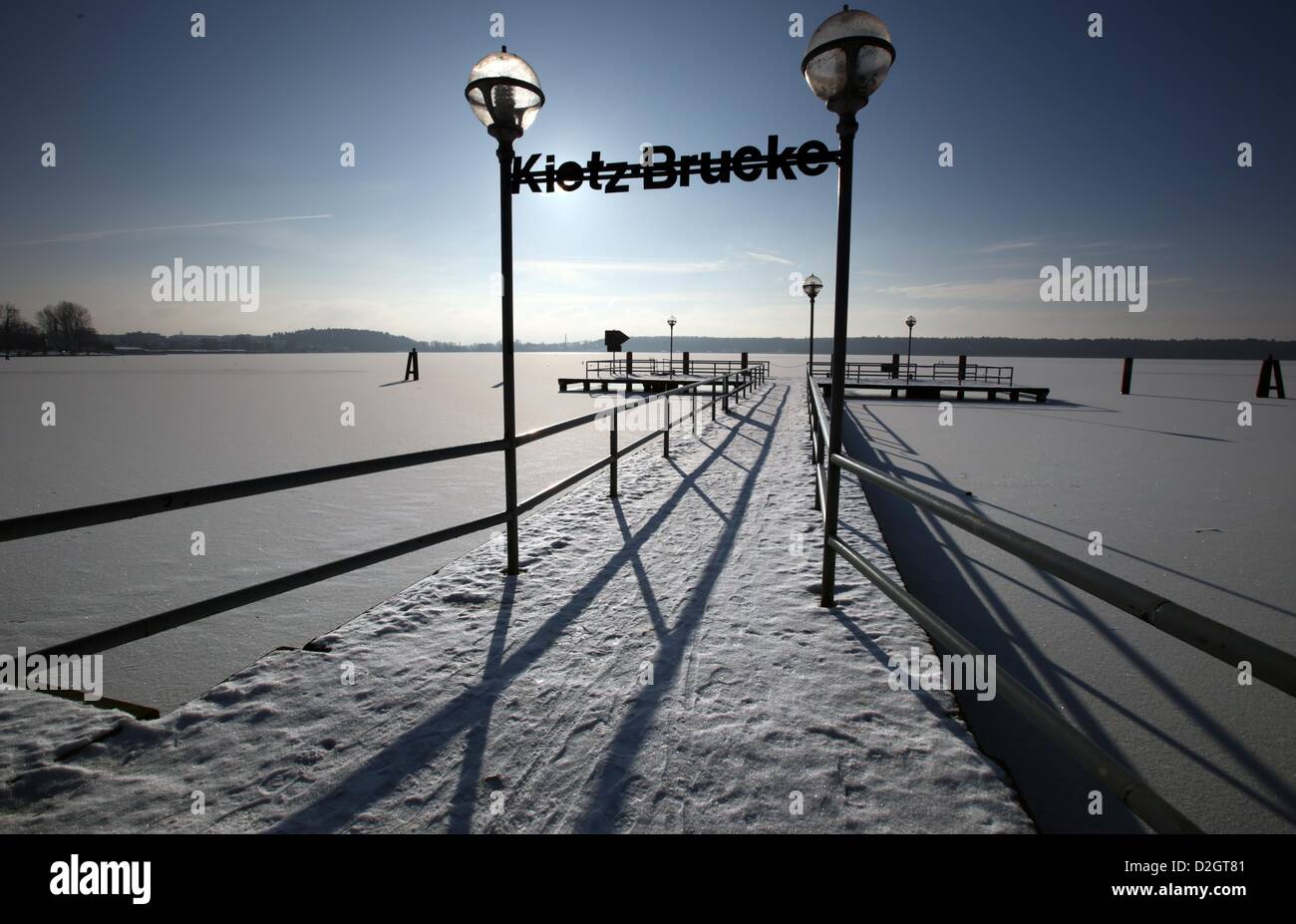 The sun shines onto the frozen Mueritz and its snow covered ice in the ...