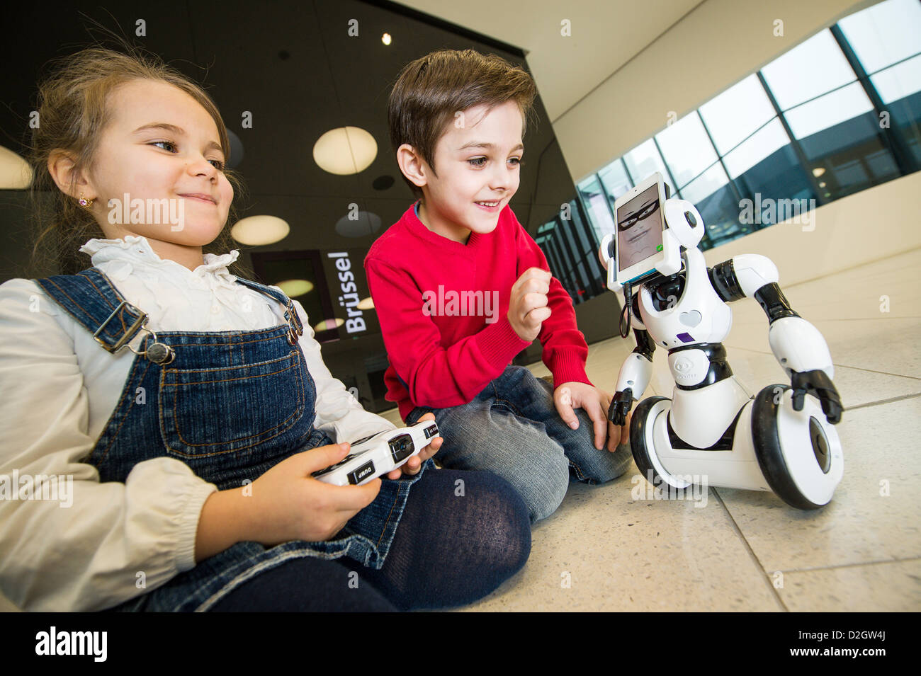 Isabella (4, L) and Julian (6) play with the 'Toy Award' nominee robot ...